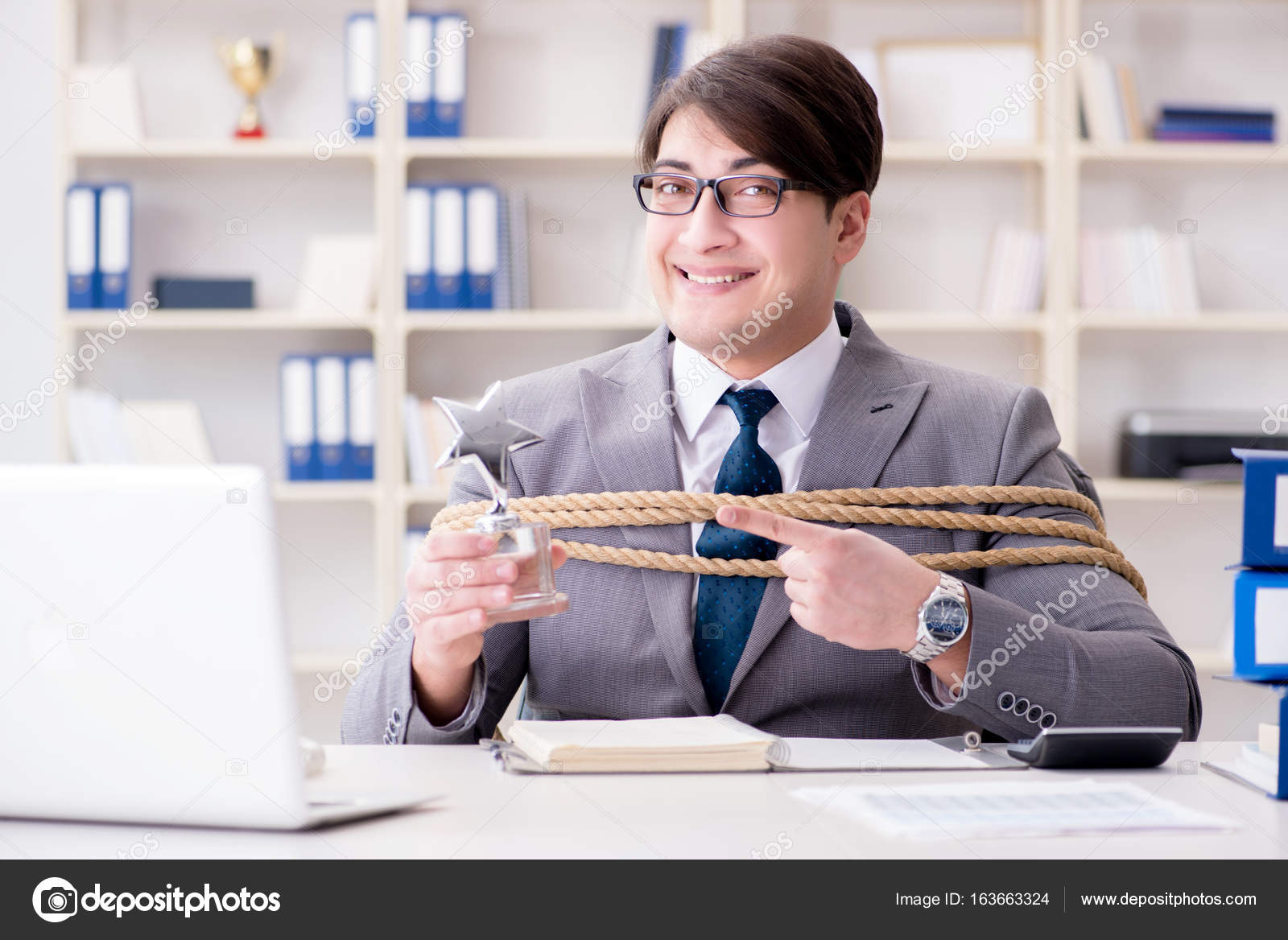 Businessman tied up with rope in office — Stock Photo © Elnur_ #163663324