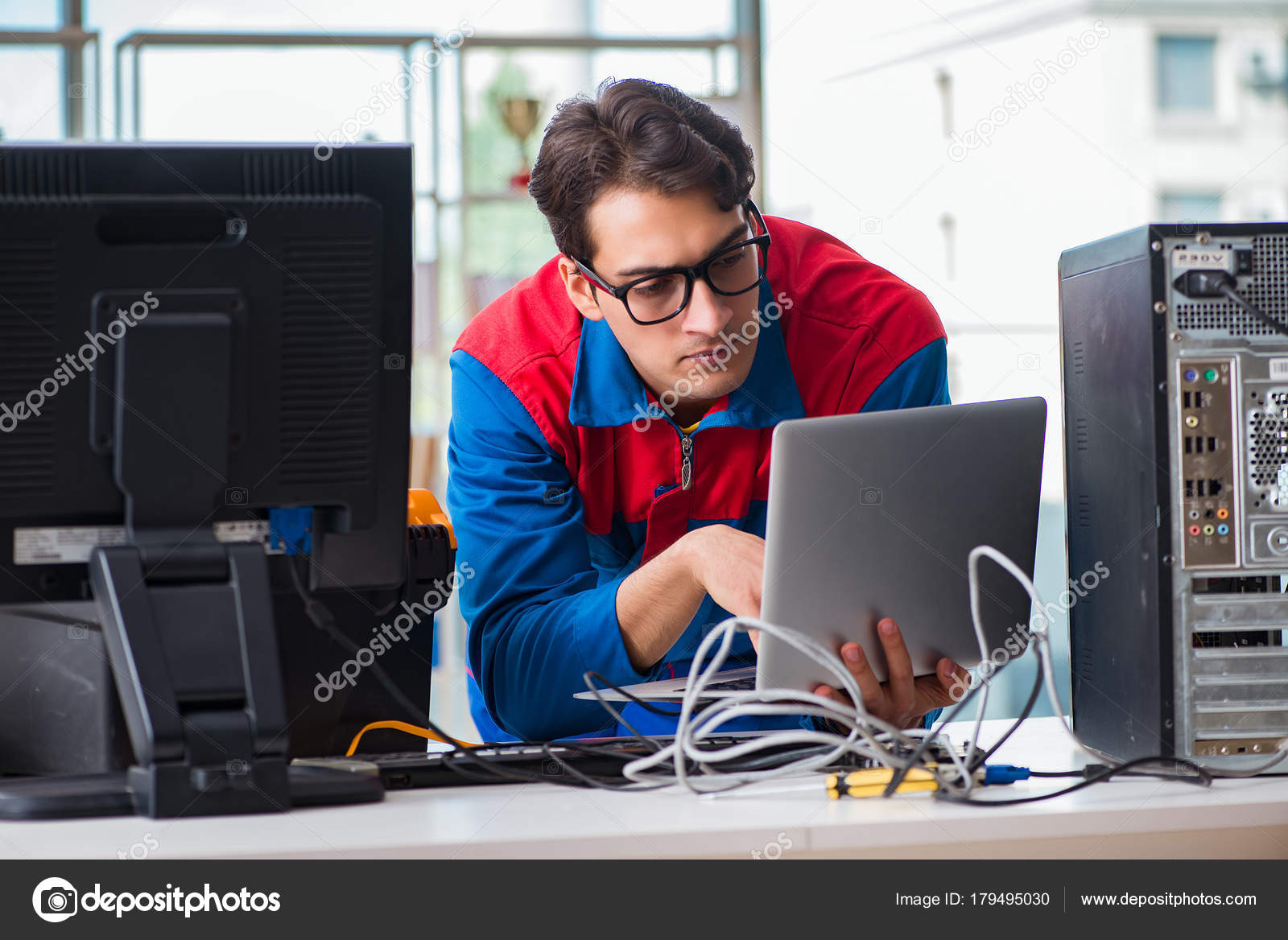 Computer repairman working on repairing computer in IT workshop Stock ...