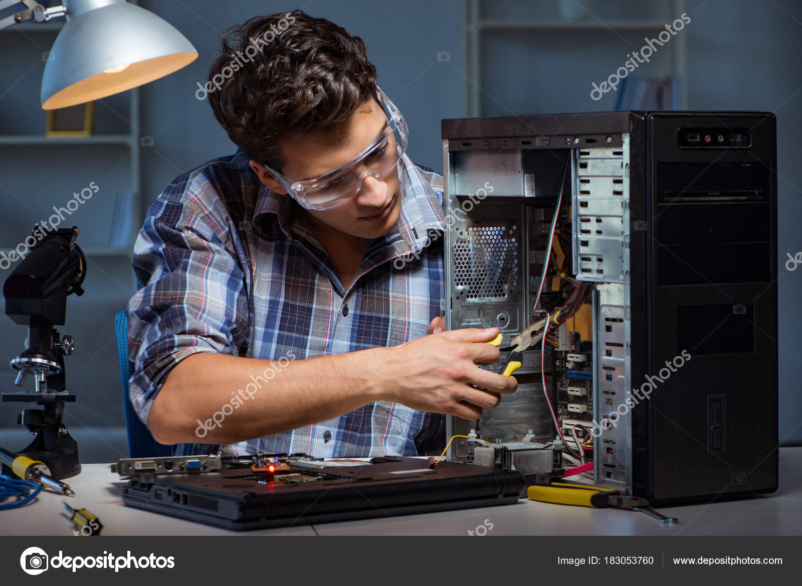 Man repairing computer desktop with pliers Stock Photo by ©Elnur_ 183053760