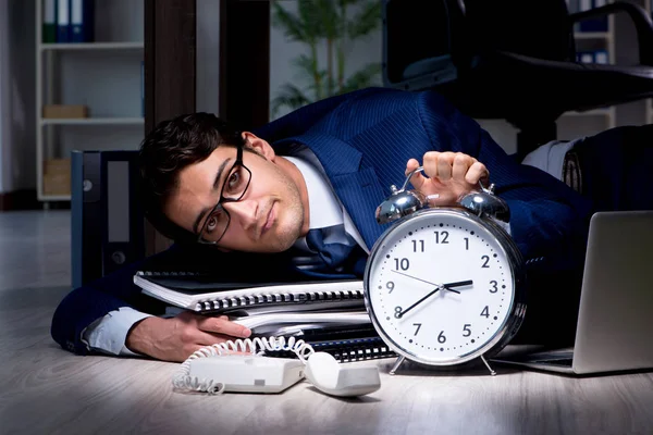 Businessman working overtime long hours late in office - Stock Image ...