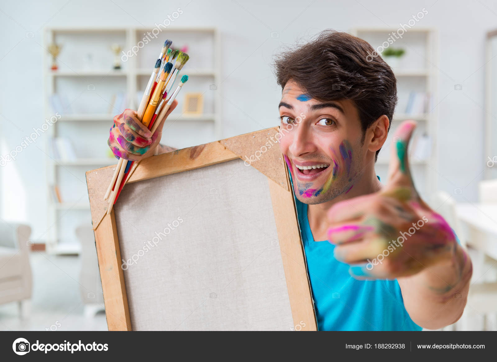 Young funny artist working on new painting in his studio — Stock Photo ...