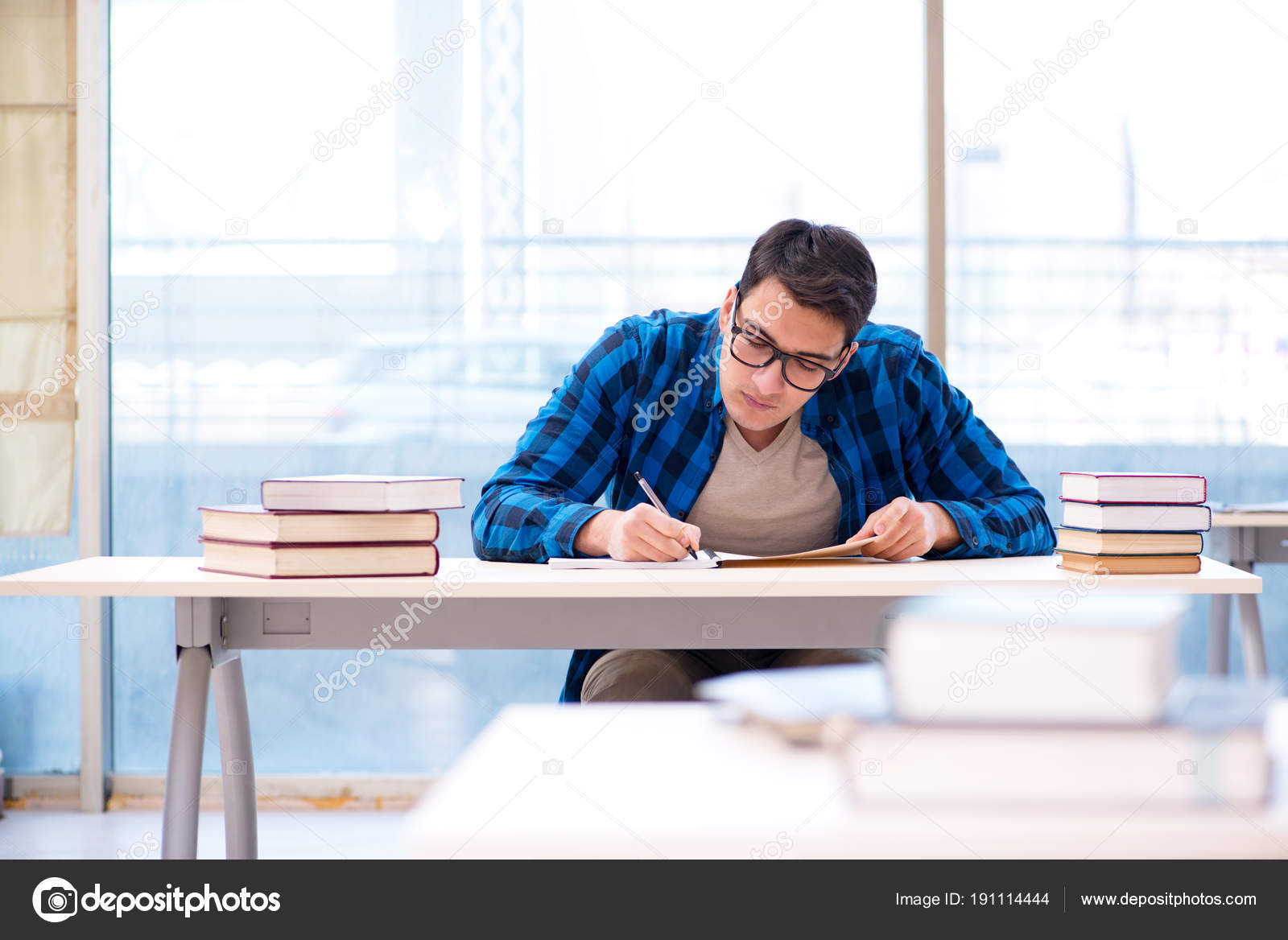 Student studying in the empty library with book preparing for ex Stock ...