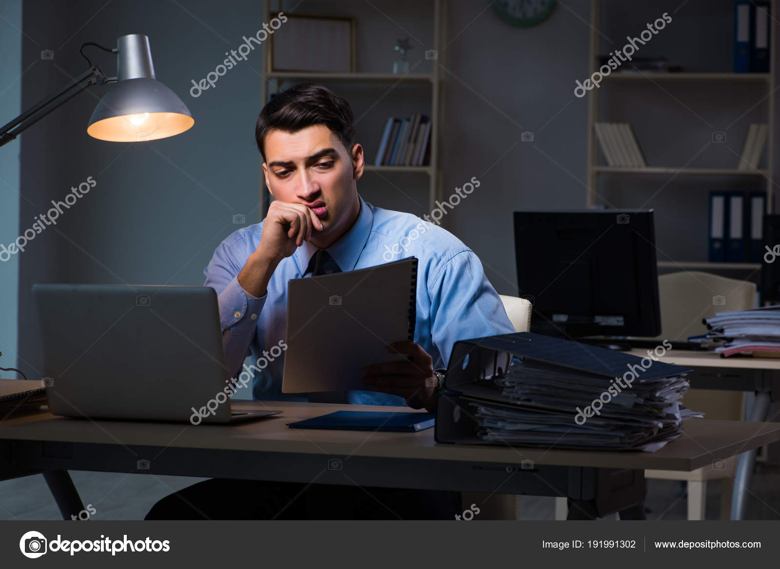 Employee working late at night at important report Stock Photo by ...