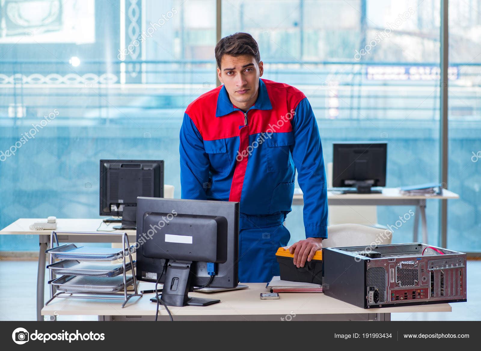 Computer technician repairing broken computer in workshop Stock Photo ...