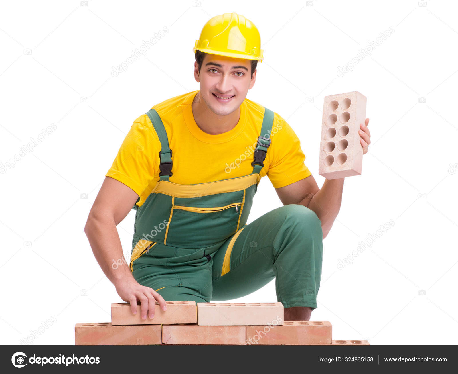 The handsome construction worker building brick wall Stock Photo by ...