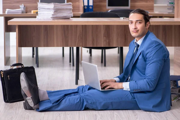 Young male employee and too many work in the office - Stock Image ...