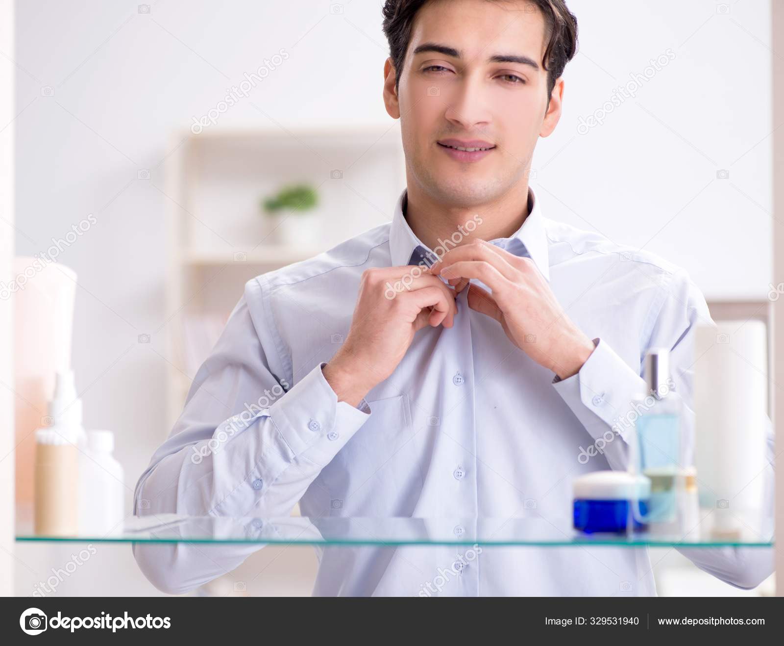 Man is getting dressed up for work in bathroom — Stock Photo © Elnur ...