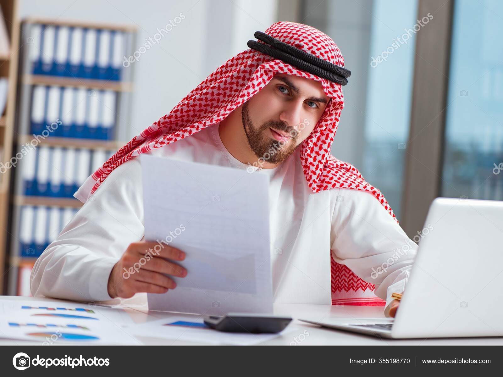 Arab businessman working on laptop computer — Stock Photo © Elnur ...