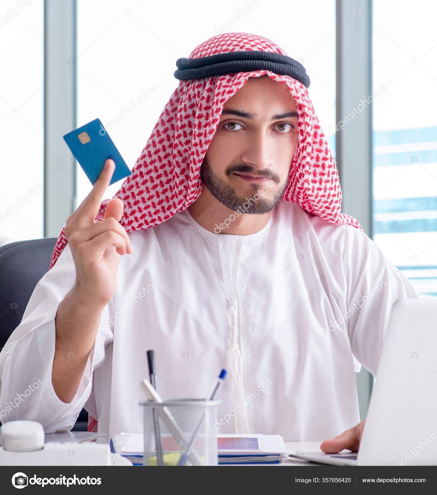Arab businessman working in the office — Stock Photo © Elnur_ #357656420