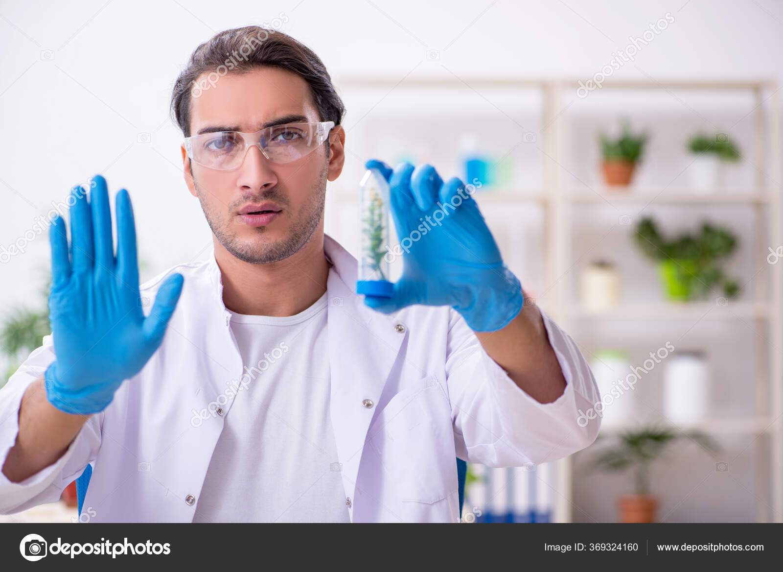 Young male chemist working in the lab — Stock Photo © Elnur_ #369324160