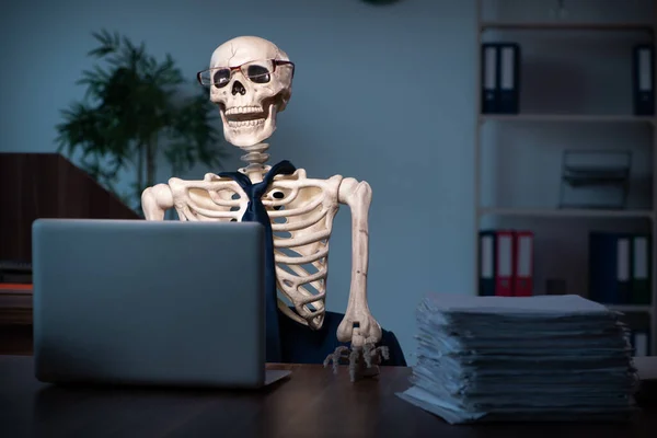 Skeleton Sitting Behind Desk