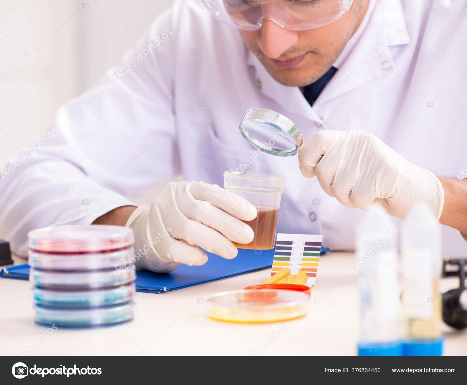 Chemist in the lab checking with ph strips — Stock Photo © Elnur ...