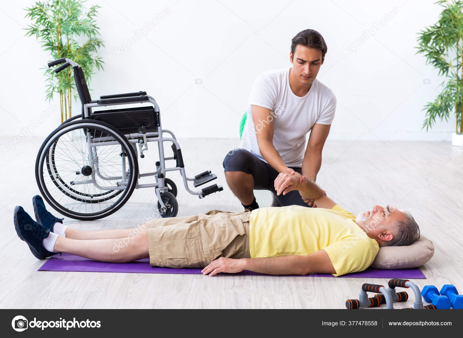 Old injured man doing exercises indoors — Stock Photo © Elnur_ #377478558