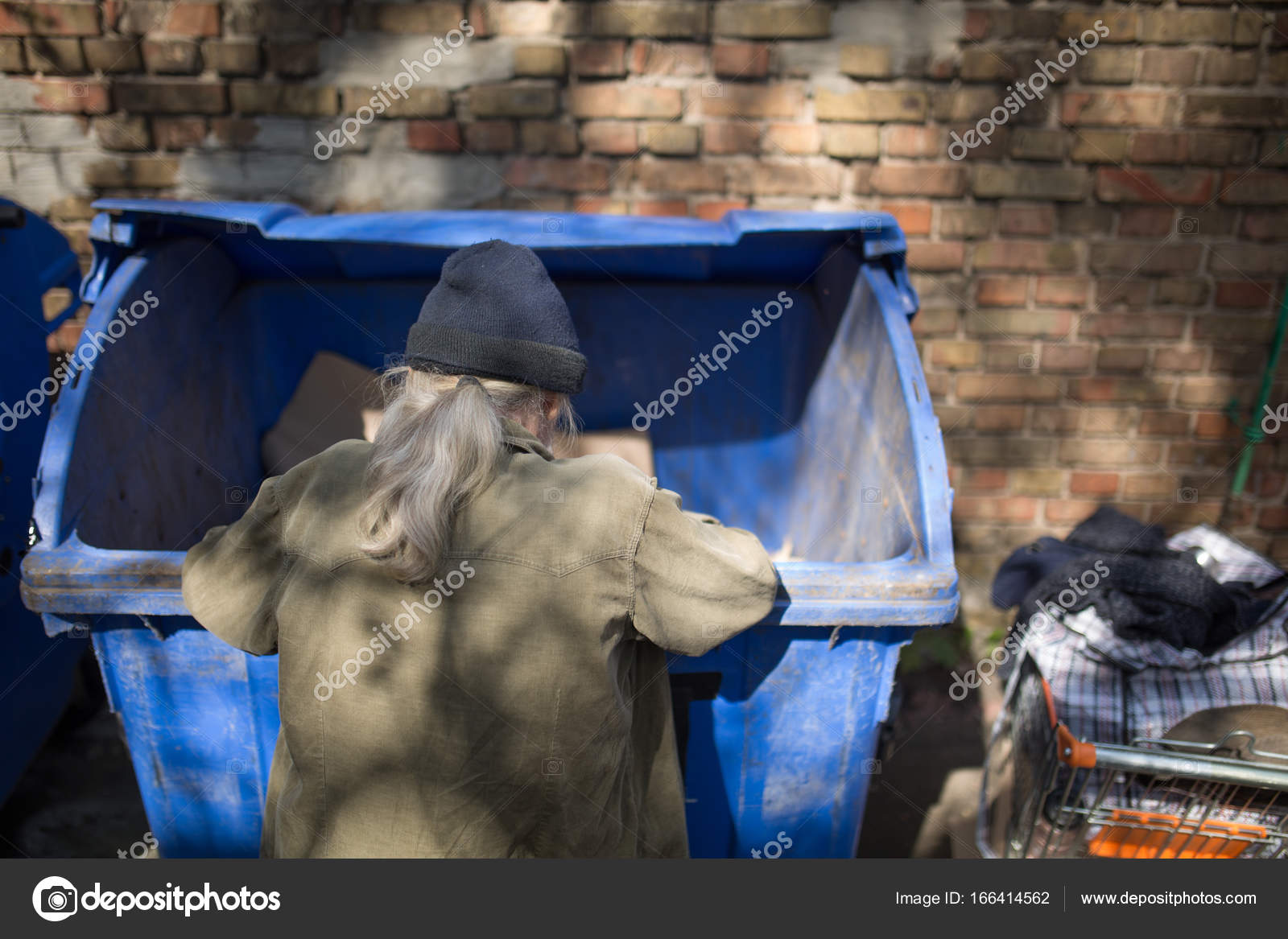 Homeless old man digging in trash can. Stock Photo by ©svyatoslavlipik ...