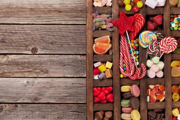 Colorful sweets box. Lollipops, macaroons, marshmallow, marmalade and ...
