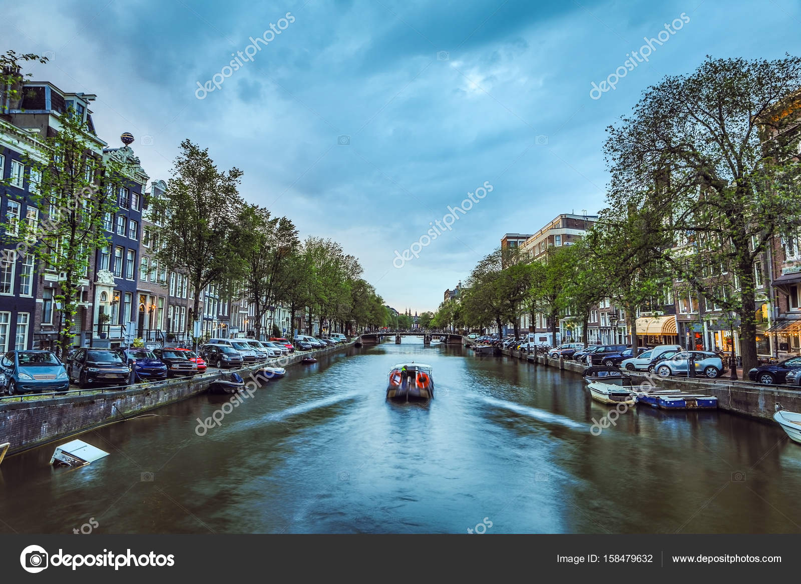 The most famous canals and embankments of Amsterdam city during sunset ...
