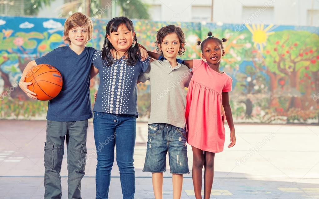 Happy Mixed Race Primary Classroom Embracing In Schoolyard Inte Stock