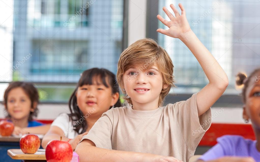 Schoolchild raising hand in classroom. Education concept Stock Photo by ...