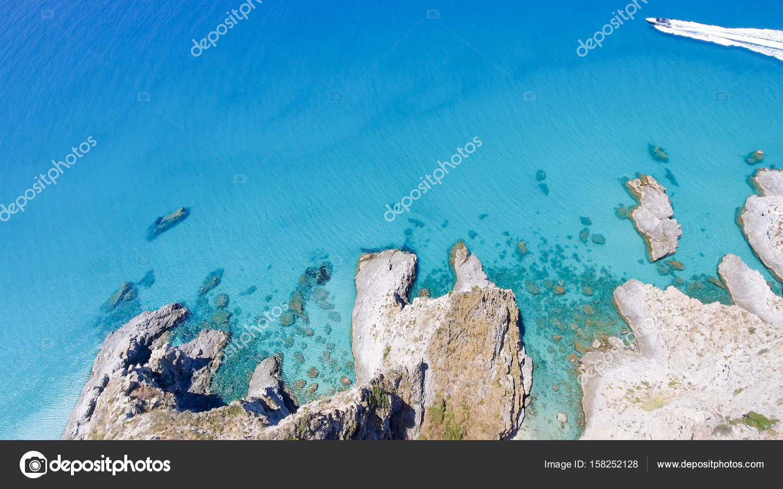 Overhead view of beautiful rocks over crystal clear ocean — Stock Photo ...