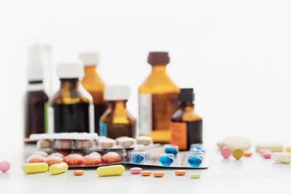 Composition of medicine bottles and pills on white background — Stock ...