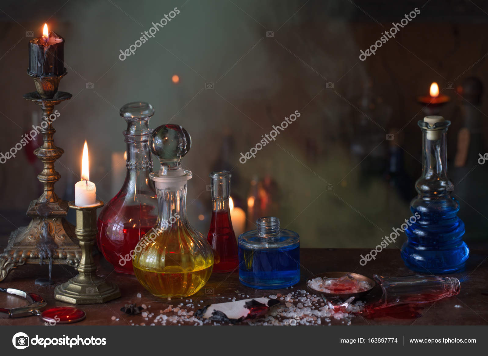 Magic potion, ancient books and candles on dark background Stock Photo ...