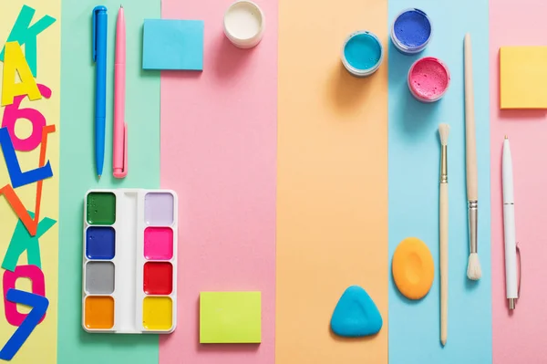 School supplies at colorful paper background texture Stock Photo by ...