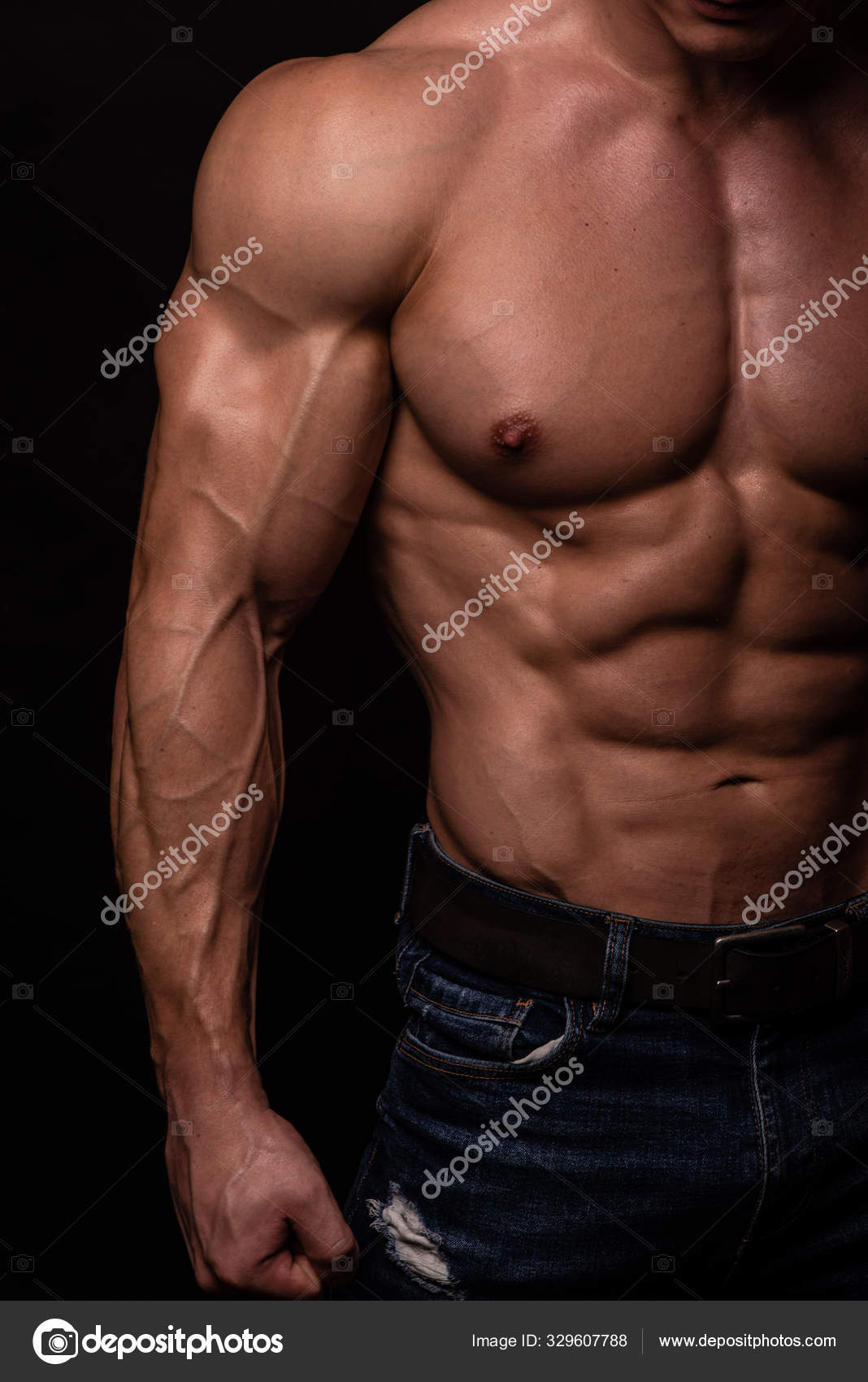 Muscled Male Model Flexing Biceps — Stock Photo © vishstudio #329607788