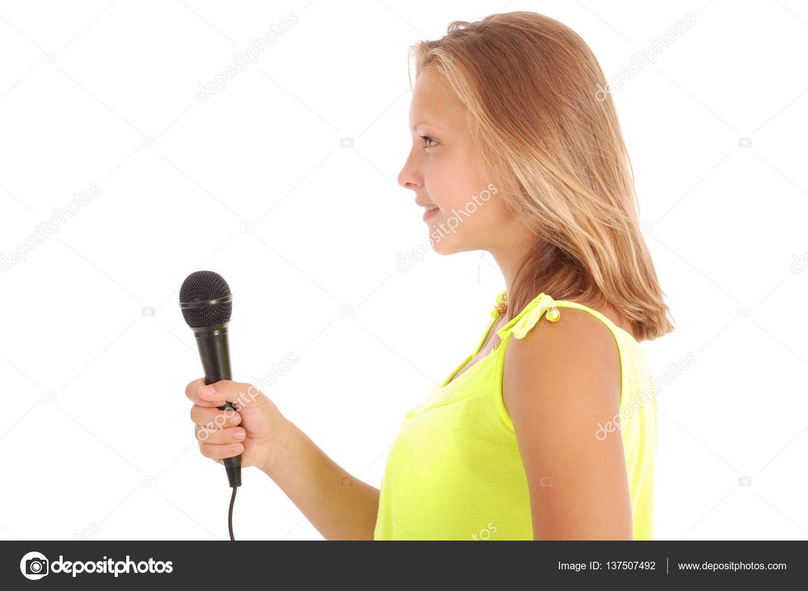 Beautiful teenage girl with microphone Stock Photo by ©akova777 137507492