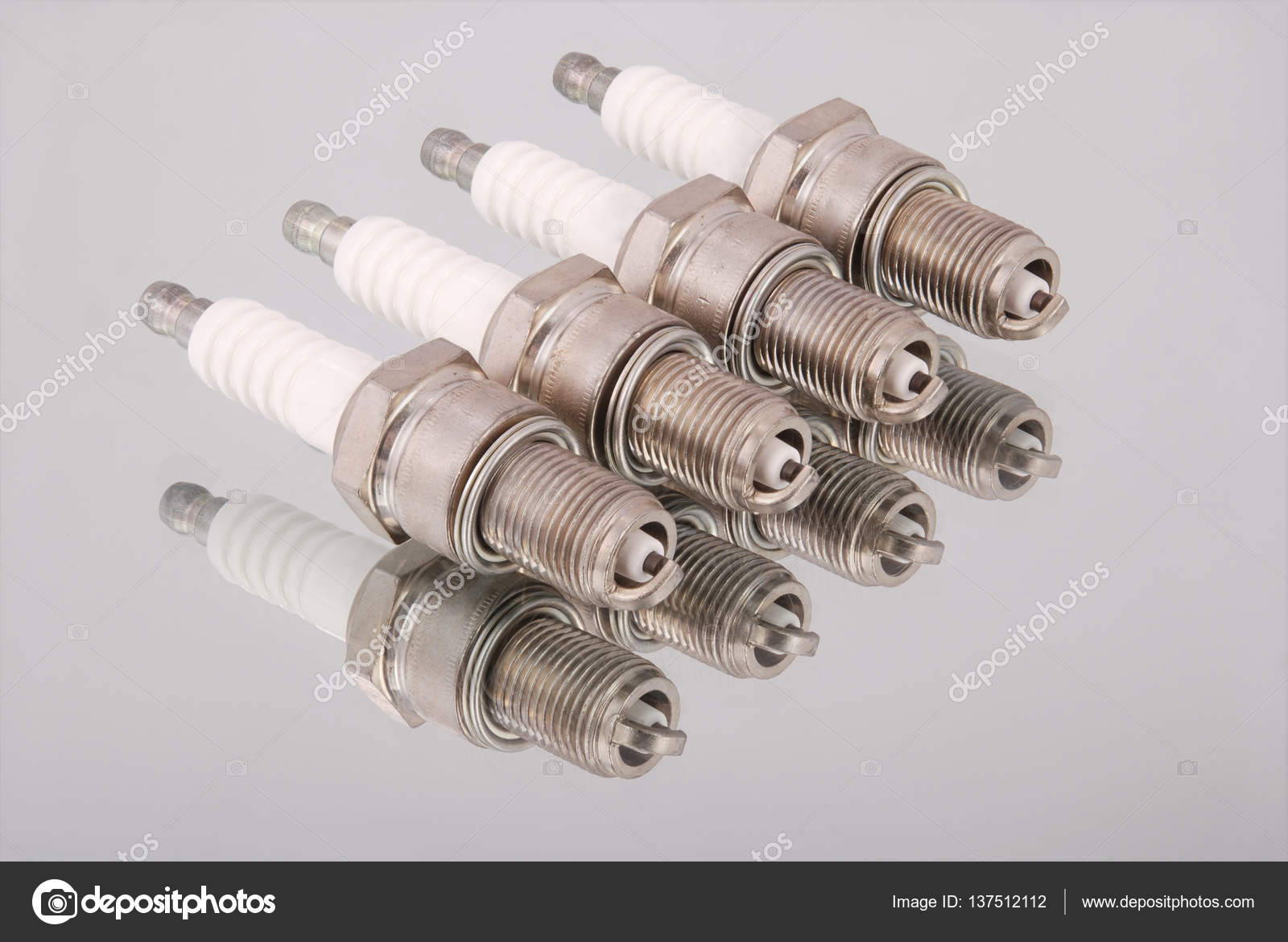 Four new spark plugs Stock Photo by ©akova777 137512112