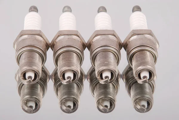 Four new spark plugs — Stock Photo © akova777 #140653518