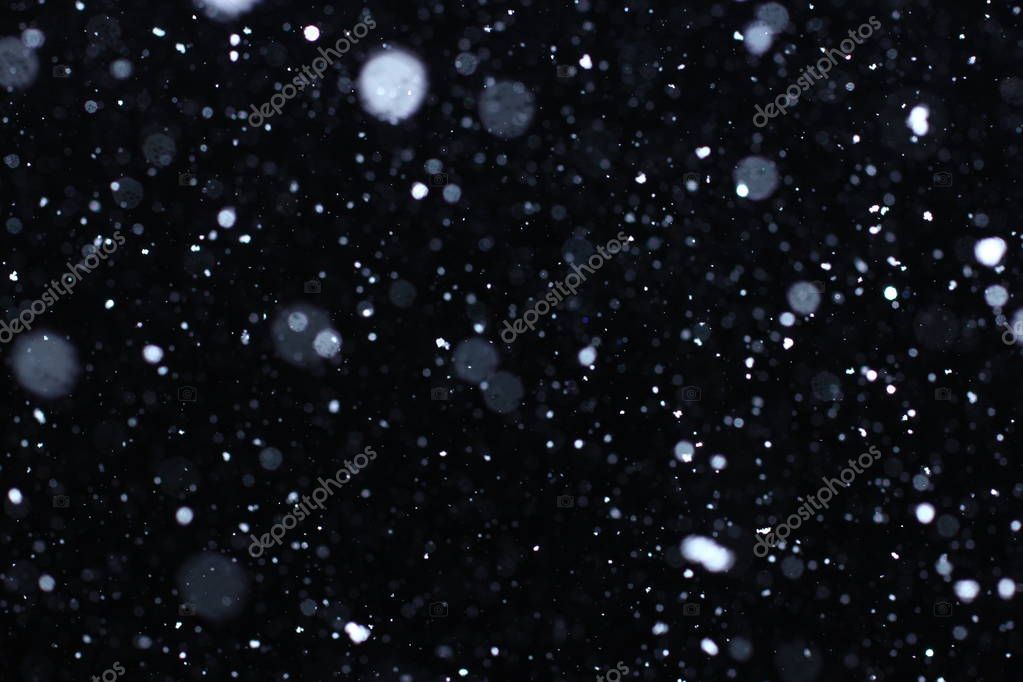 Snowstorm texture. Bokeh lights on black background, shot of flying ...