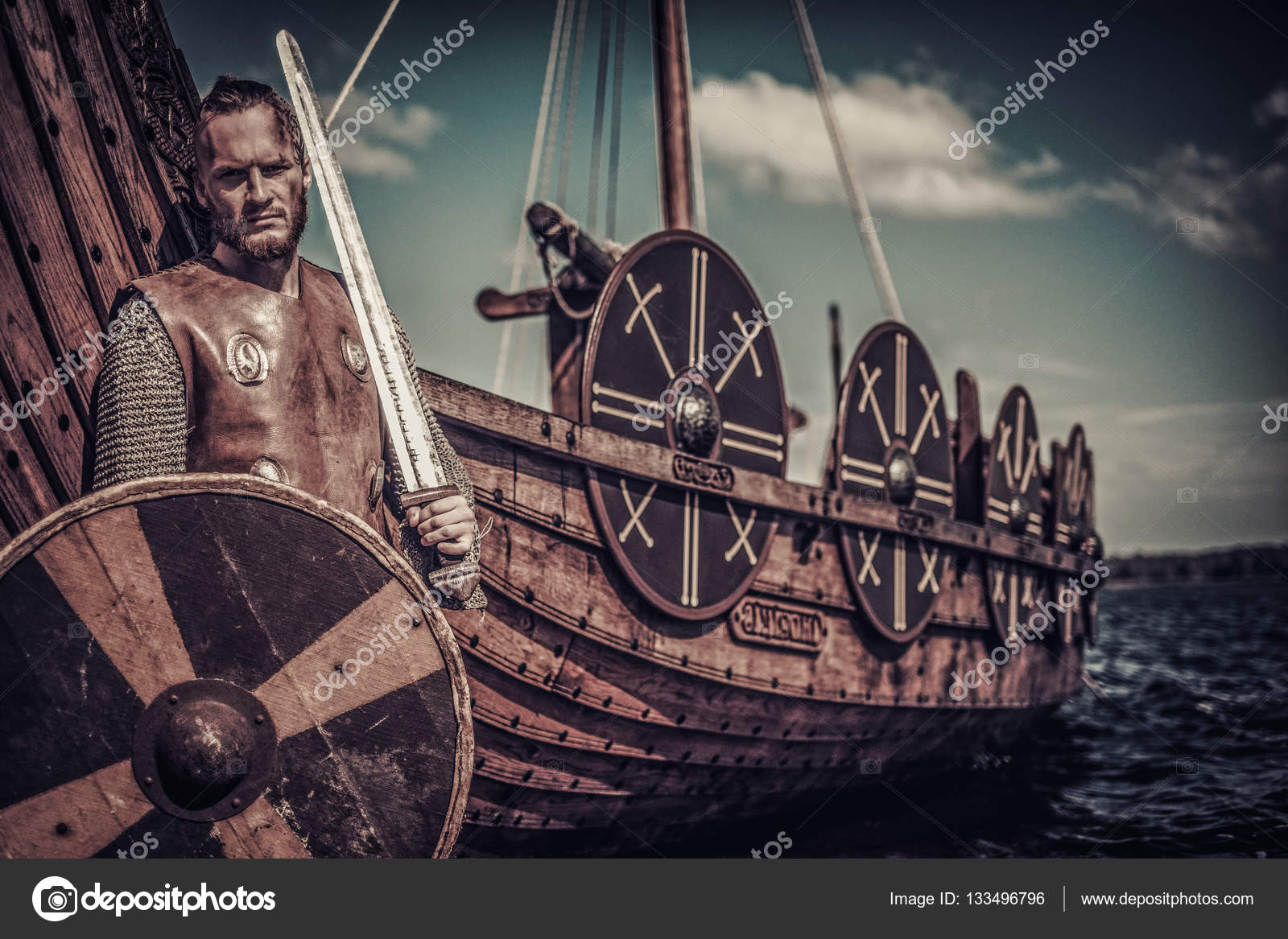 Viking warrior with sword and shield standing near Drakkar — Stock ...