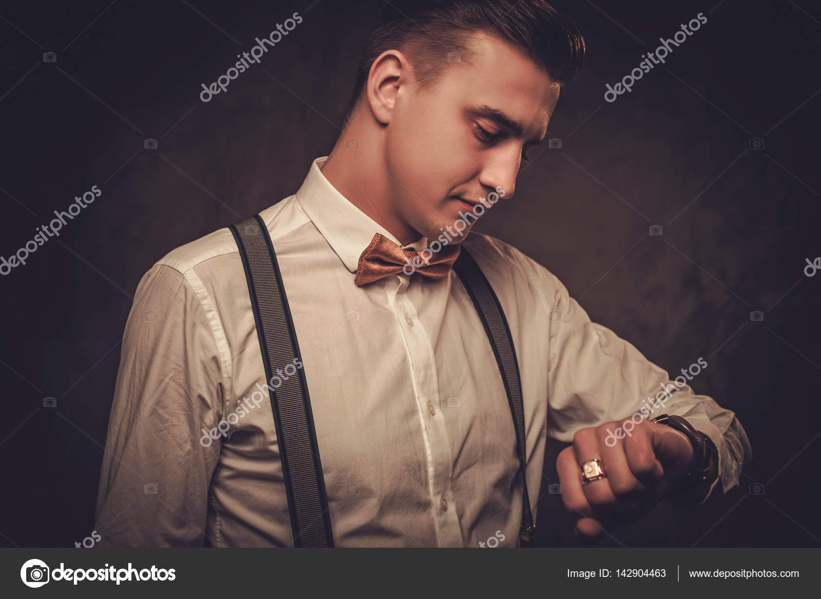 Sharp dressed man wearing bow tie looking at wristwatch — Stock Photo ...