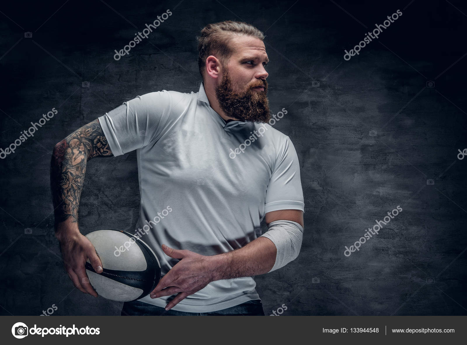 Brutal bearded rugby player in action. Stock Photo by ©fxquadro 133944548