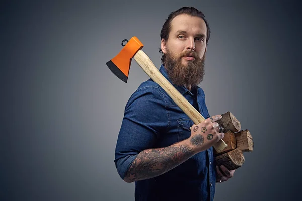 Bearded male holding axe and posing in studio Stock Photo by ...