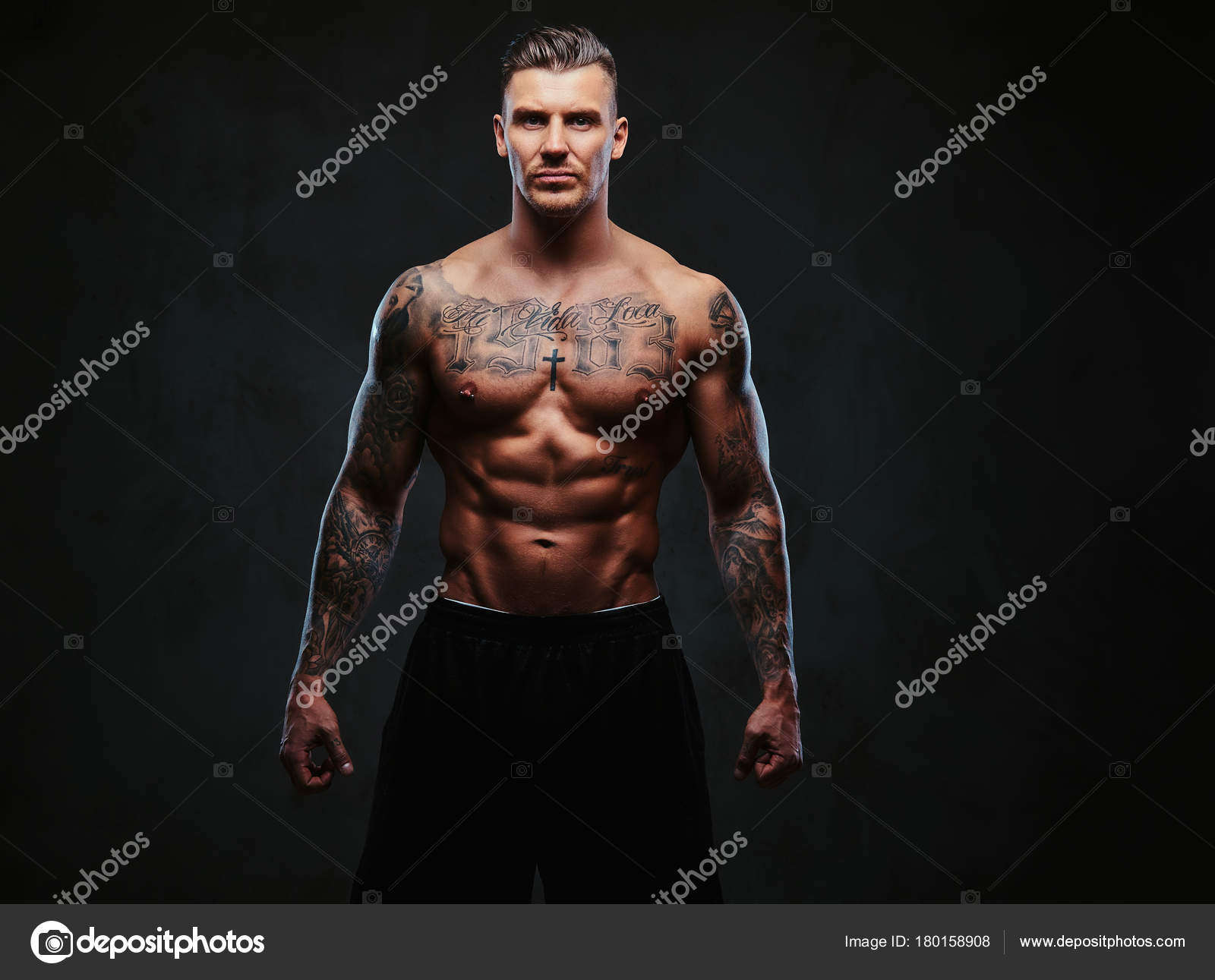 A muscular tattooed man on a dark background. Stock Photo by ©fxquadro ...