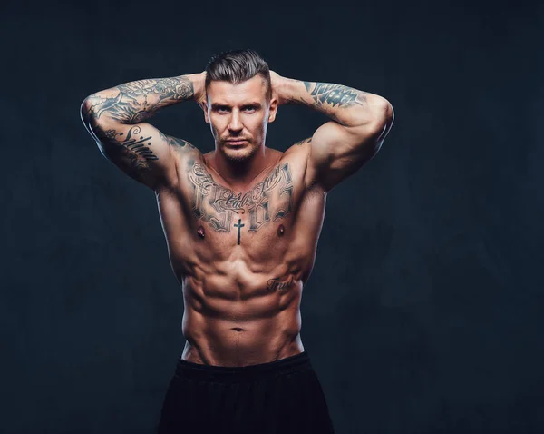 A muscular tattooed man on a dark background. Stock Photo by ©fxquadro ...