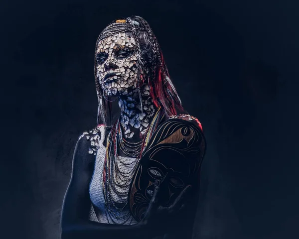 Portrait of a scary African shaman female with a petrified cracked skin ...