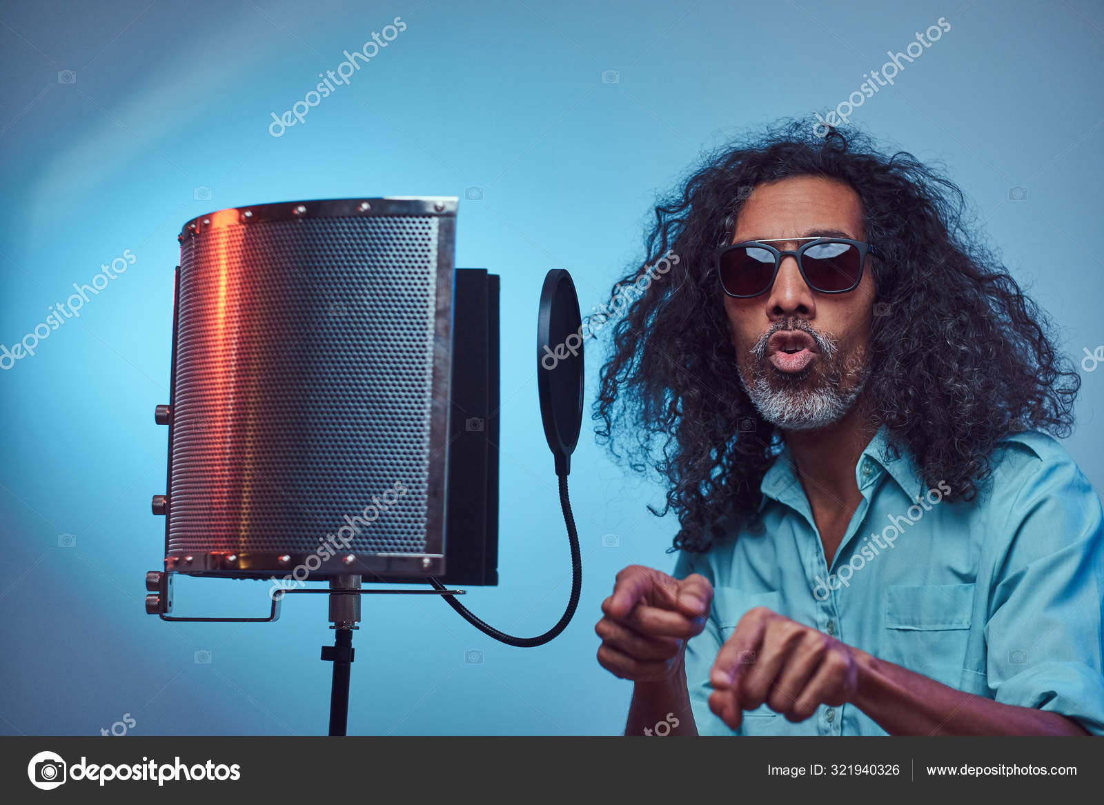 African vocal artist wearing a blue shirt emotionally writing song in ...