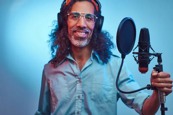 African Rastafarian singer male wearing a blue shirt and beanie ...