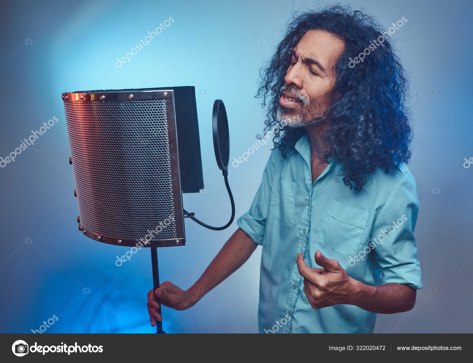 African vocal artist wearing a blue shirt emotionally writing song in ...