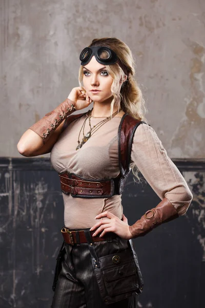 Portrait of a beautiful steampunk woman in Aviator glasses over grey ...