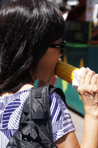 Older woman eating corn on the cob Stock Photos, Royalty Free Older ...