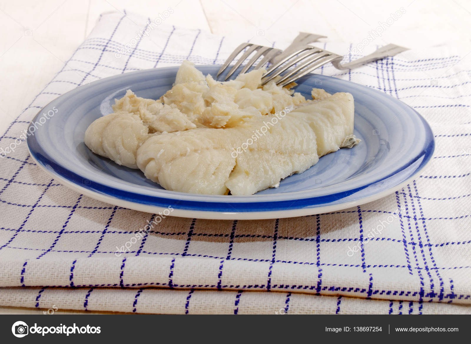 Boiled hake filet on a plate with fork Stock Photo by ©Szakaly 138697254