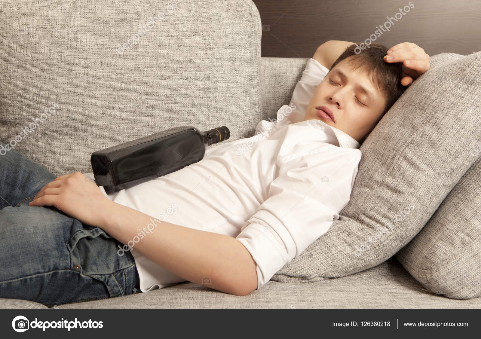 Drunkard. A young man with a drinking problem is relaxing Stock Photo ...