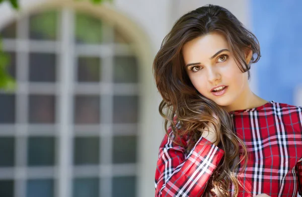 Portrait of young woman in stylish checked red blouse - Stock Image ...
