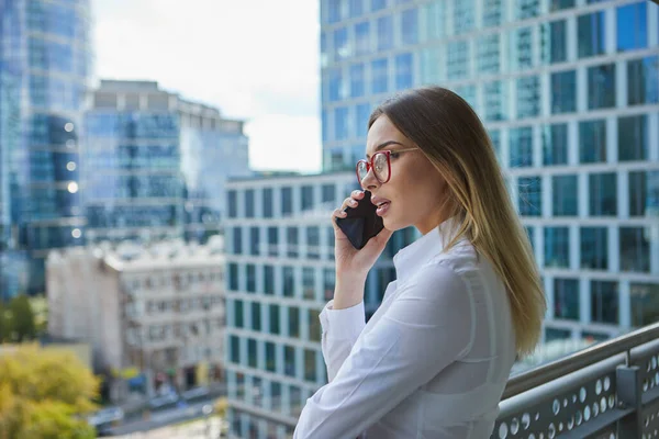 Real estate agent talking on the phone. in the background modern ...