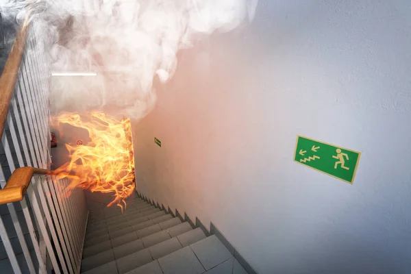 Emergency exit and fire in the building — Stock Photo © ambrozinio ...