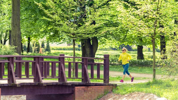Woman running in summer park — Stock Photo © blasbike #45397509