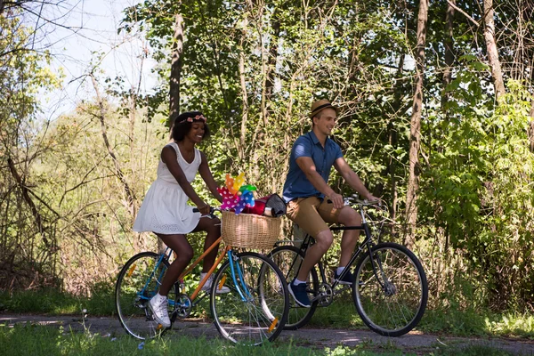 Young multiethnic couple having a bike ride in nature - Stock Image ...